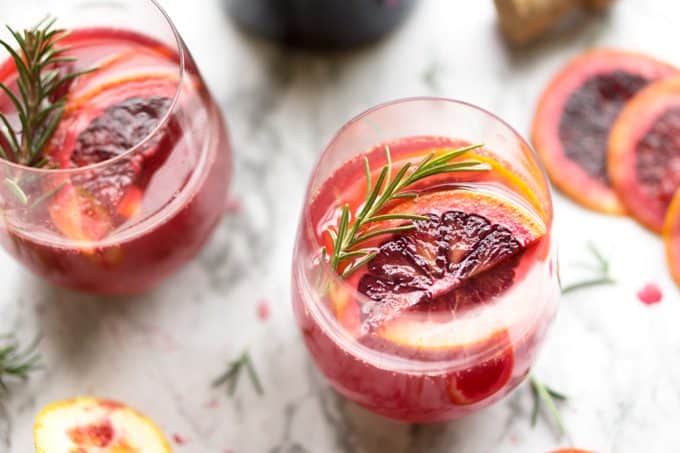 Blood Orange Mimosa Recipe: Sparkling wine cocktail w/ rosemary garnish
